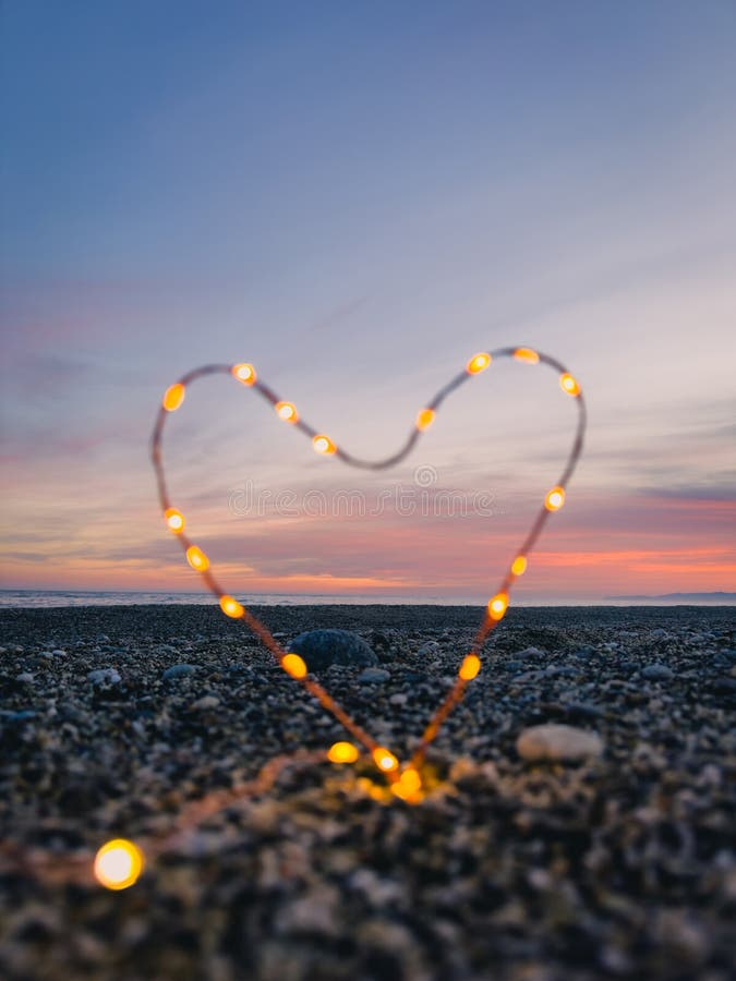 Heart Symbol with Bright Fairy Lights on the Beach Stock Image - Image ...
