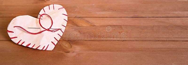 The Heart Which is Cut Out from Paper and Sewed by a Red Thread Stock ...