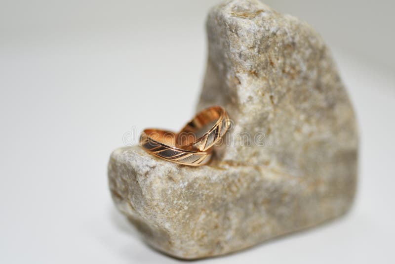 Hearth Rock with Two Golden Rings. Stock Image - Image of design ...