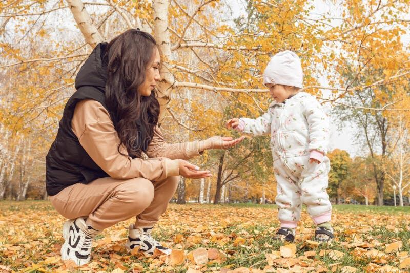 Heartwarming Scene of Mother and Child Playfully Interacting in a Fall ...