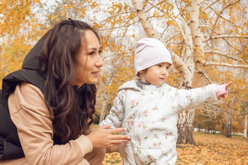 Heartwarming Scene of Mother and Child Playfully Interacting in a Fall ...