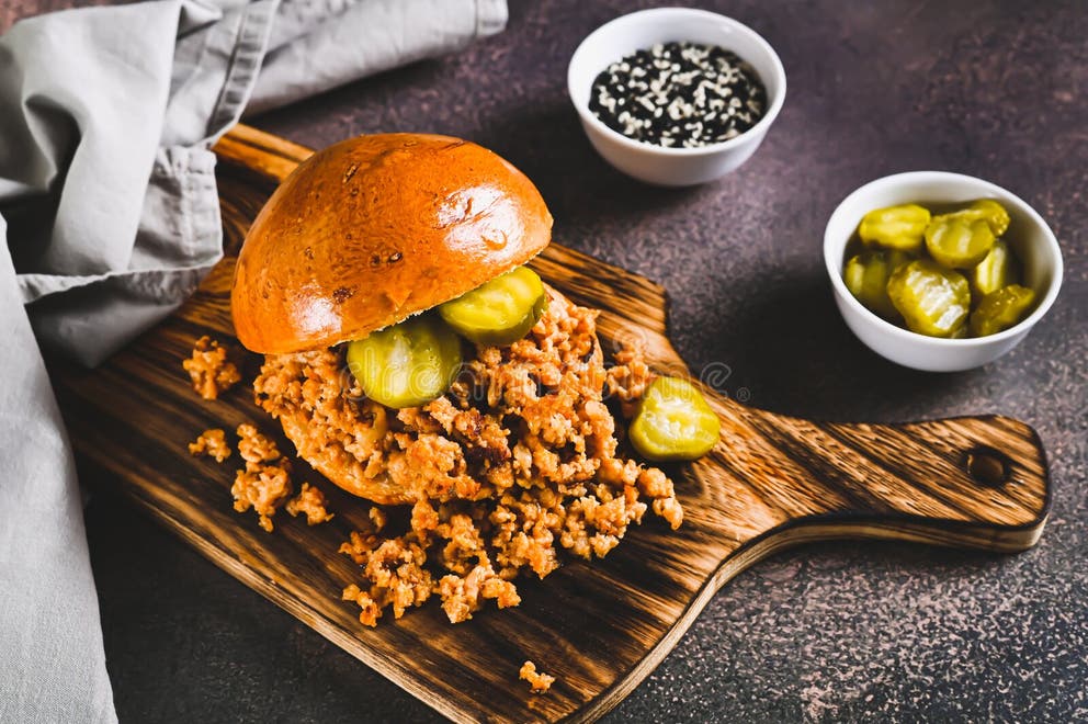 Hearty Burger with Ground Beef and Pickles on a Board on a Table Stock ...