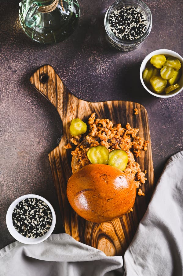 Hearty Burger with Ground Beef and Pickles on a Board on a Table Top ...