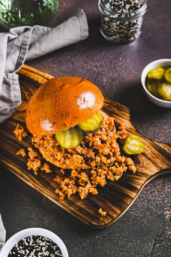 Hearty Burger with Ground Beef and Pickles on a Board on a Table ...
