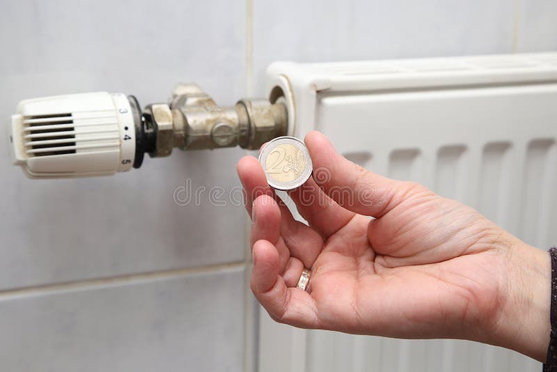 Heating Battery and Hand Holding Coin Stock Photo - Image of closeup ...
