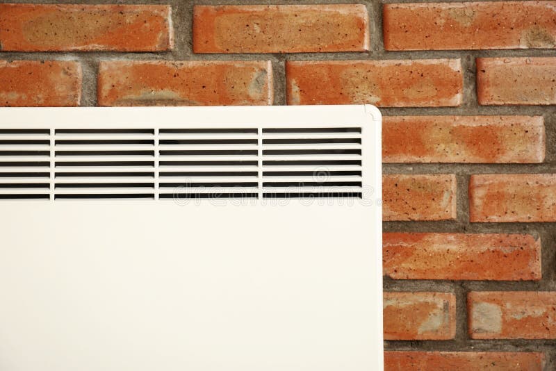 Heating con on brick wall stock image. Image of season - 129999535
