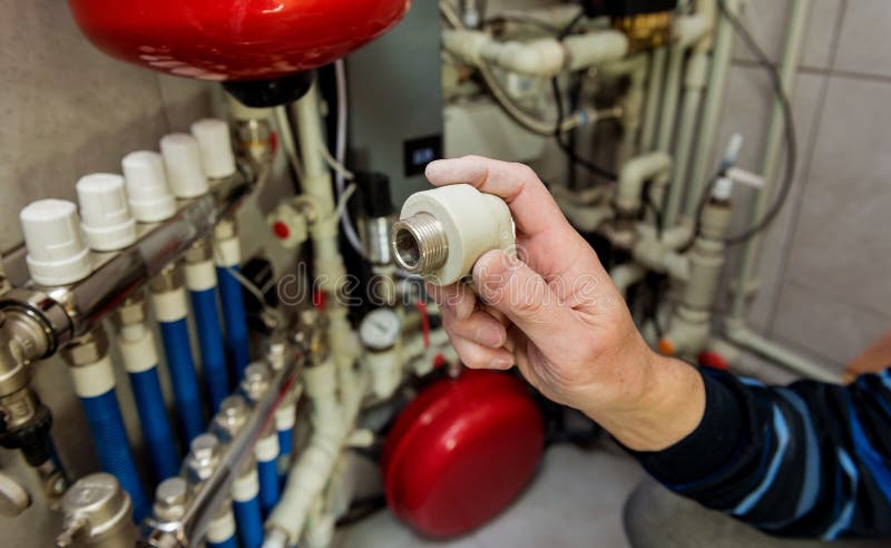 Heating Engineer Fixing Modern Heating System in Boiler Room. Stock ...