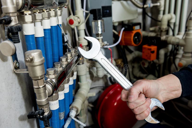 Heating Engineer Installing Modern Heating System in Boiler Room. Stock ...