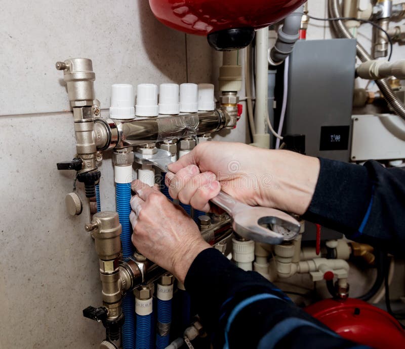 Heating Engineer Installing Modern Heating System in Boiler Room. Stock ...
