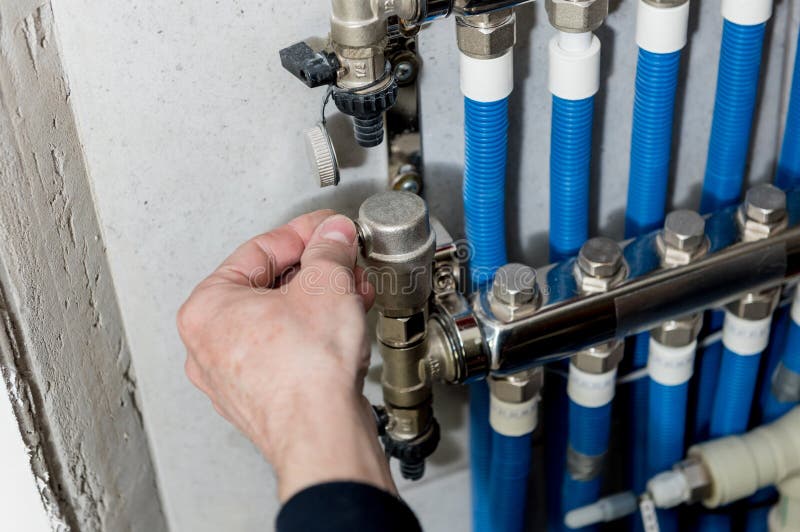 Heating Engineer Installing Modern Heating System in Boiler Room. Stock ...