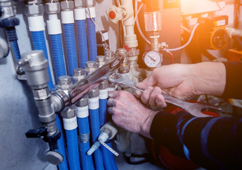 Heating Engineer Installing Modern Heating System in Boiler Room. Stock ...