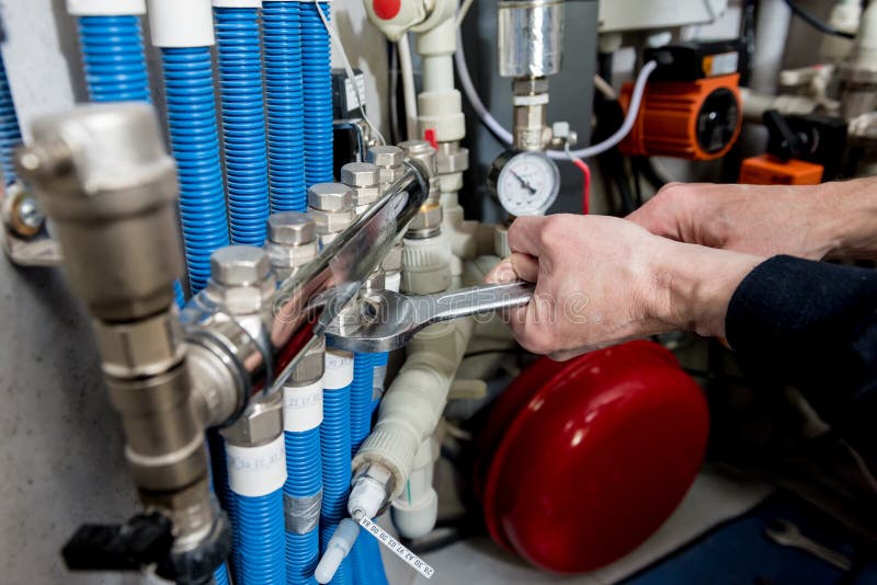 Heating Engineer Installing Modern Heating System in Boiler Room. Stock ...