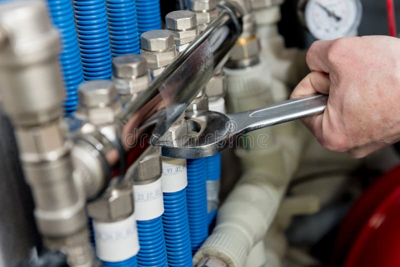 Heating Engineer Installing Modern Heating System in Boiler Room. Stock ...