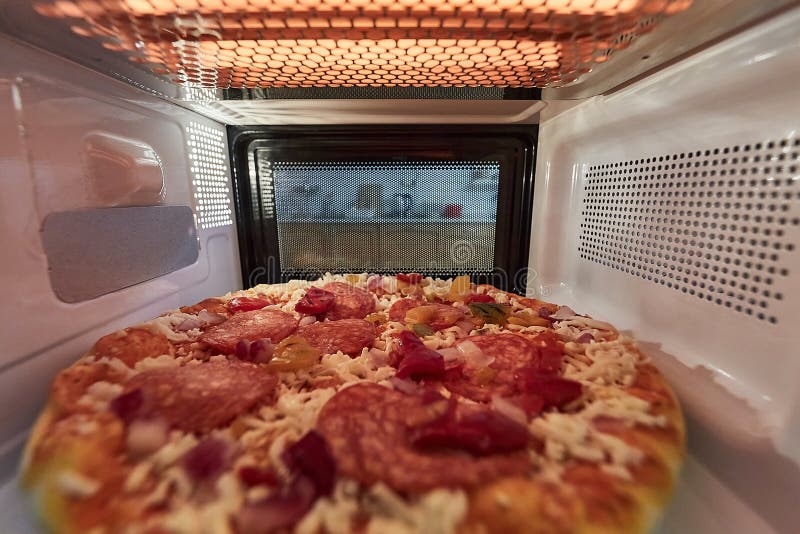 Heating Pizza in a Microwave Oven Stock Photo - Image of microwaving ...