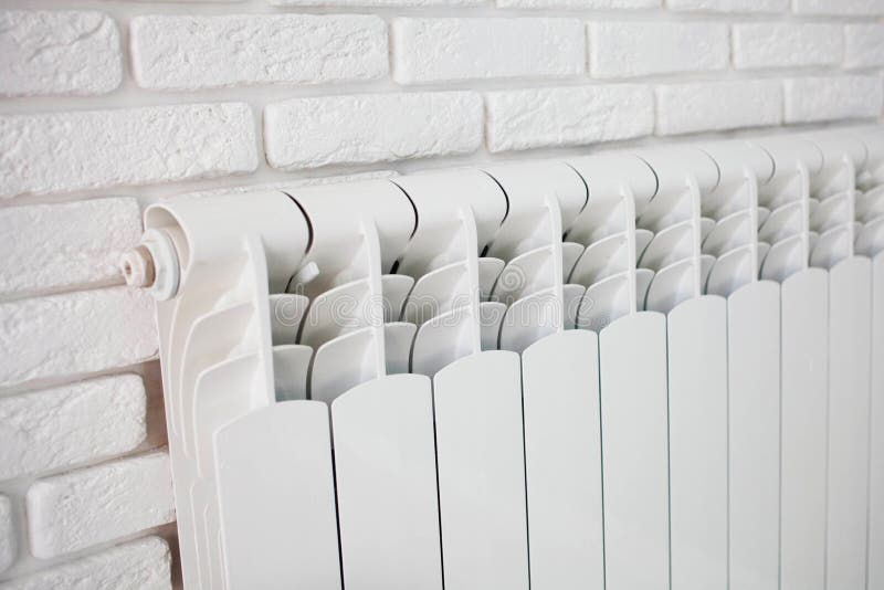 A Heating Radiator on the Brick Plaster Wall Stock Photo - Image of ...