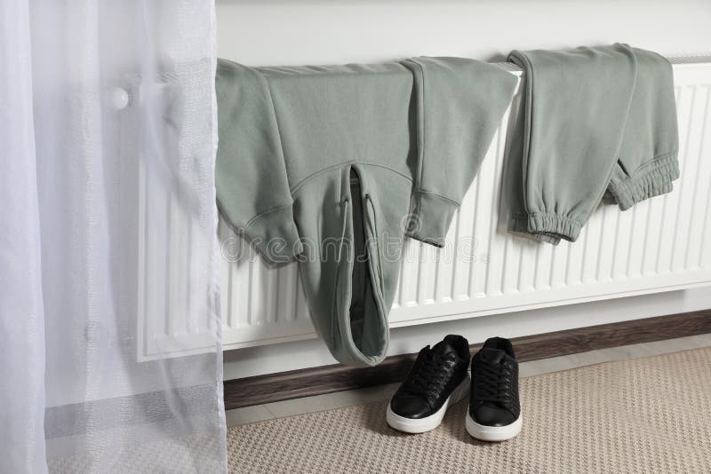 Heating Radiator with Clothes and Shoes in Room Stock Image - Image of ...