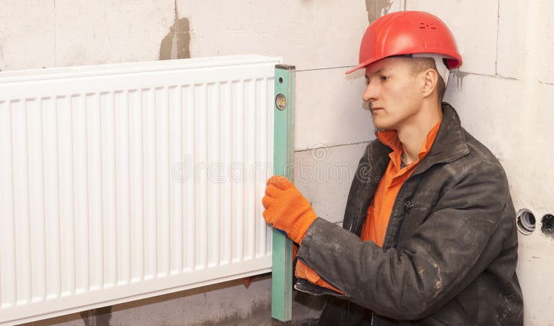 Radiator installation stock photo. Image of fitter, building - 22584422