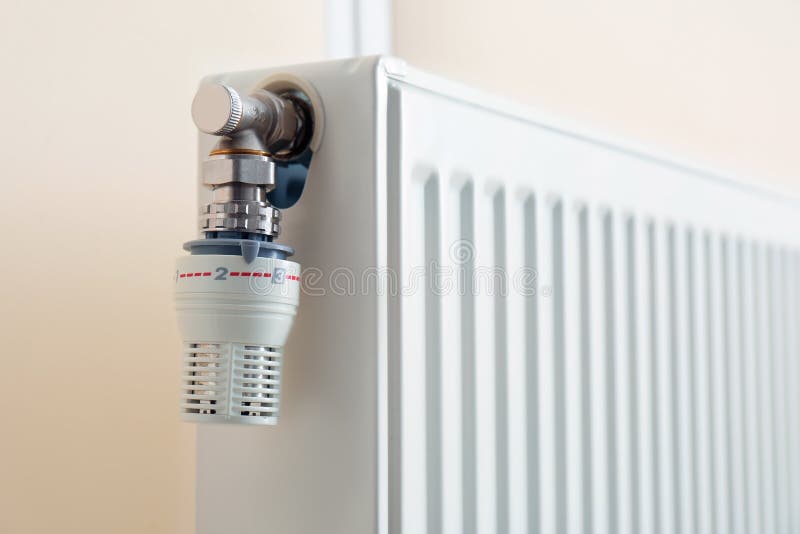Heating Radiator with Thermostat Near Light Wall Stock Image - Image of ...