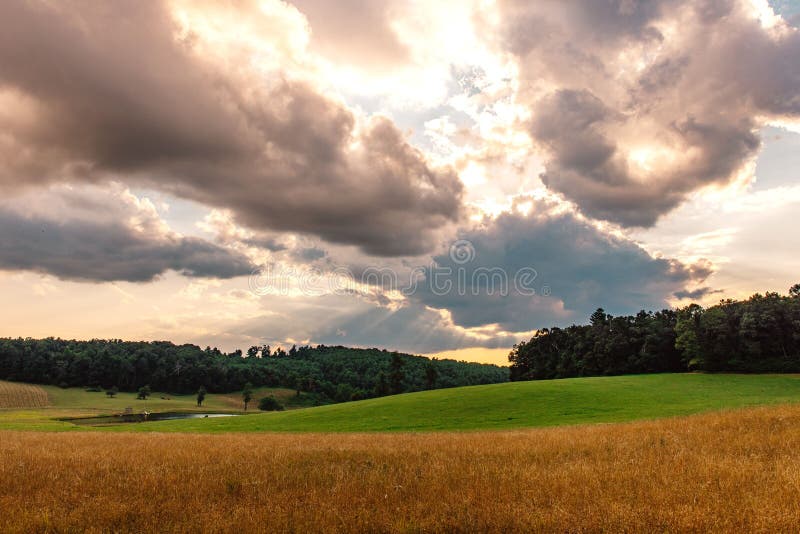 Heavenly Effect of Sunrays on the Cloudy Sky Above a Grass Field Stock ...