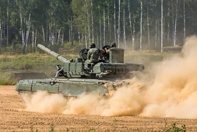 Heavy Armor Tank with Dust from Under the Caterpillars in the Field of ...