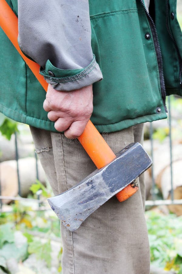 Heavy Ax with Orange Handle in His Hand at the Working Men. Stock Photo ...