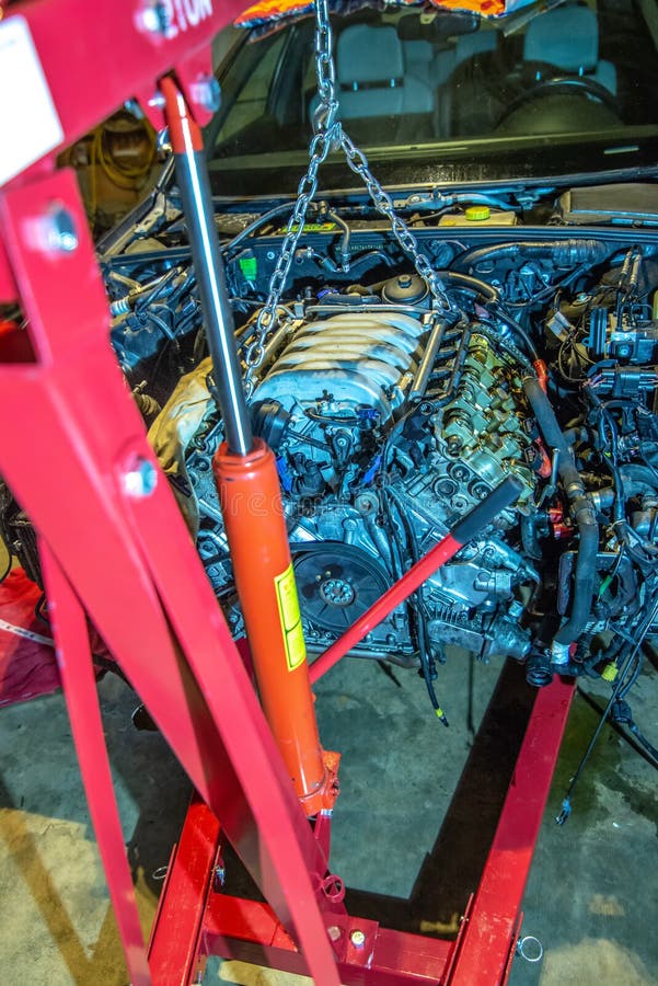 Heavy car engine on hoist stock image. Image of vertical - 154644499