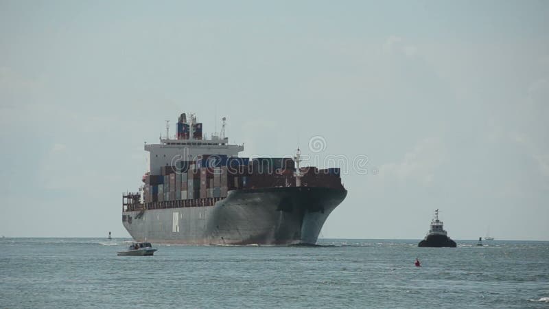 A Cargo Ship is Skillfully Navigating Tranquil Waters As the Day ...