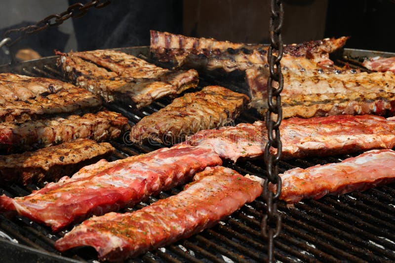 Heavy Cast Iron Grill Supported by Chains with Pork Ribs Cooked and ...