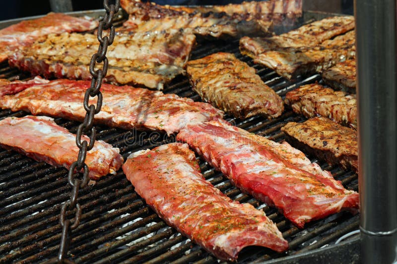 Heavy Cast Iron Grill Supported by Large Chains with Pork Ribs Cooked ...