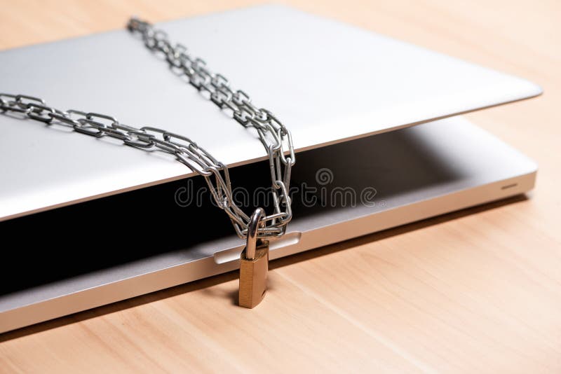 Heavy Chain with a Padlock Around a Laptop on Table. Stock Image ...