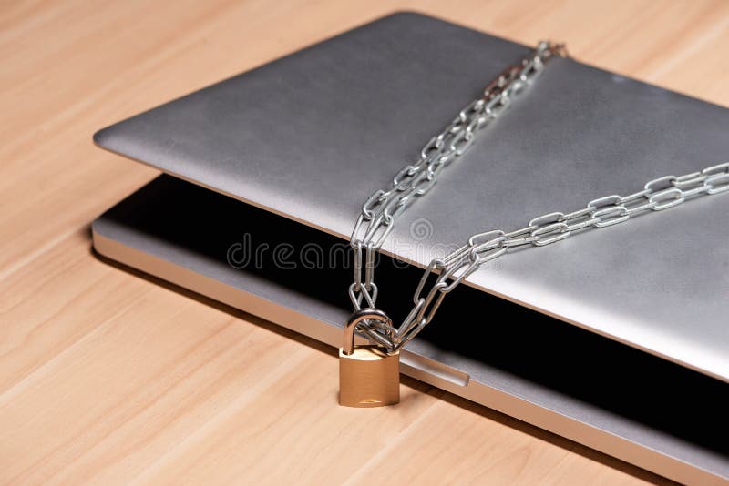 Heavy Chain with a Padlock Around a Laptop on Table Stock Photo - Image ...