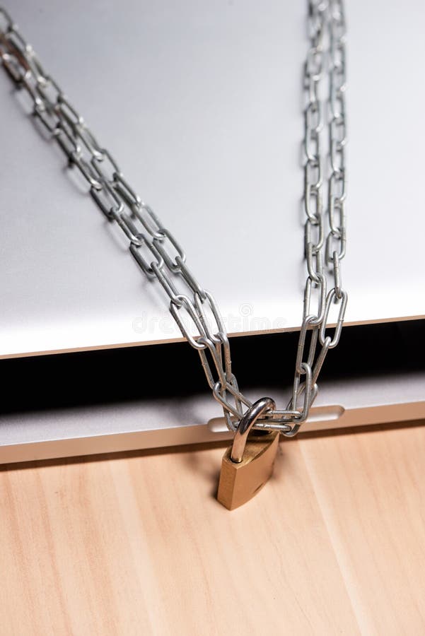 Heavy Chain with a Padlock Around a Laptop on Table Stock Photo - Image ...