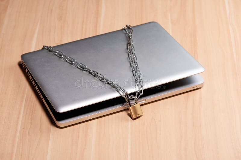 Heavy Chain with a Padlock Around a Laptop on Table. Stock Image ...