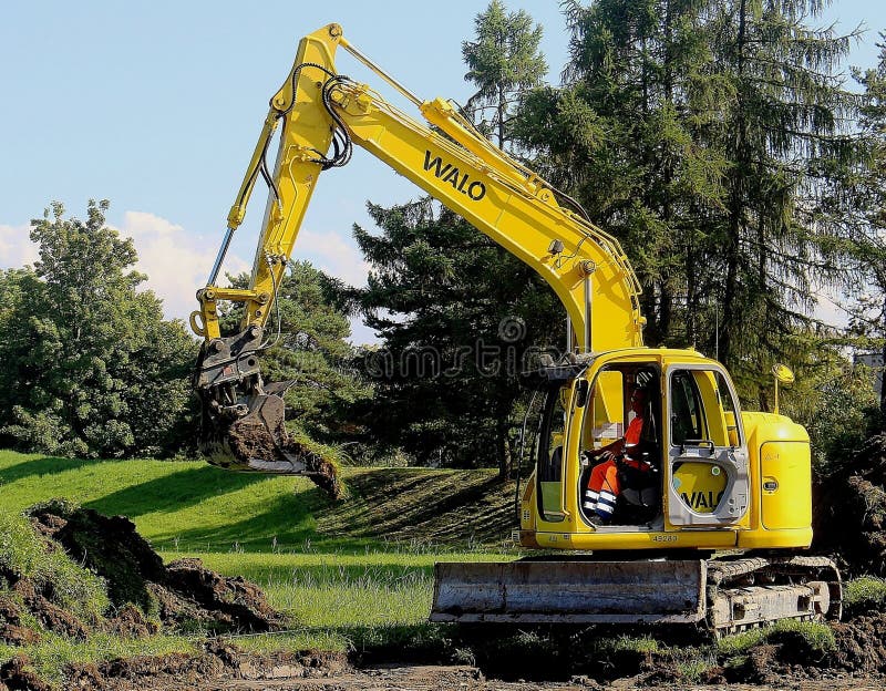 Excavator at Work in Front of Residential Building Under Construction ...