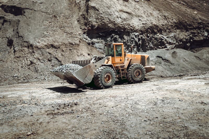 Wheel Loader Transporting Gravel and Loading Dumper Trucks Stock Photo ...