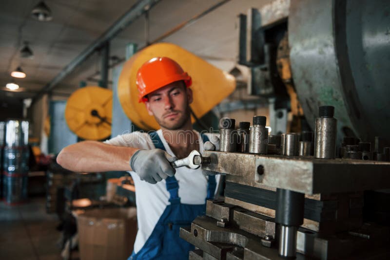 Heavy Construction. Man in Uniform Works on the Production Stock Photo ...