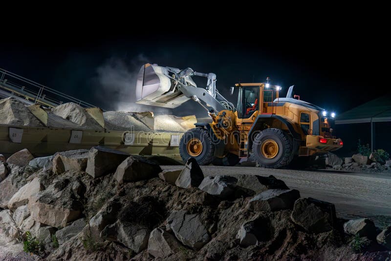 Heavy Construction and Mining Machinery Unloading Gravel into Silos on ...