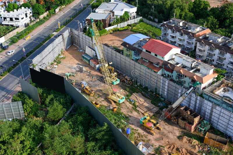 Heavy Crane Machine in Construction Site and Safety Hedge Stock Photo ...