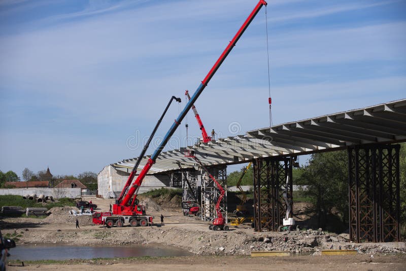 Heavy Cranes Lifting Bridge Segments during Large-scale Construction ...