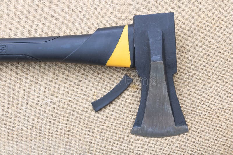 A Heavy-Duty Axe with a Partially Broken Handle Resting on Burlap ...