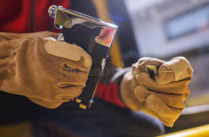 Heavy Duty Staple and Brad Tacker in Contractor Hands Stock Photo ...