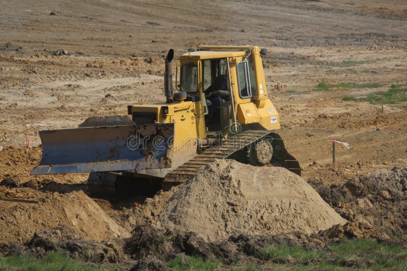 Heavy Equipment in the Field Leveling the Ground. Stock Photo - Image ...