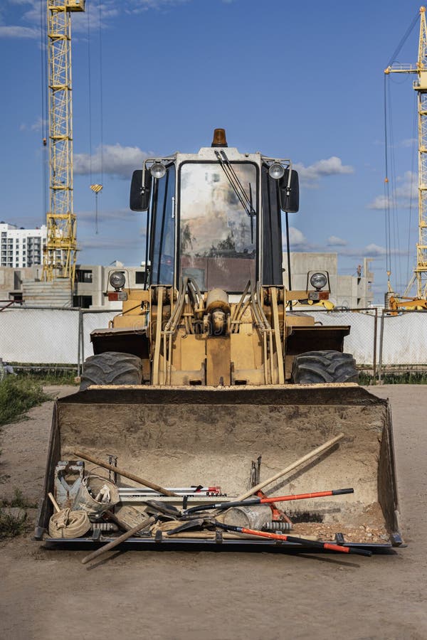 Heavy Front Loader on a Construction Site with a Construction Tool in ...