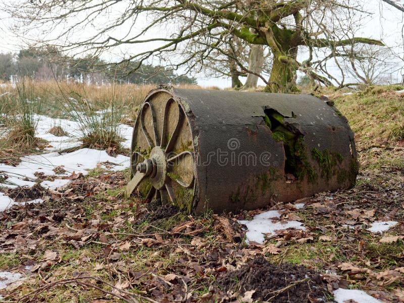 Heavy Grass Roller. Rustic Iron Wheel in an Overgrown, Snowy Field with ...