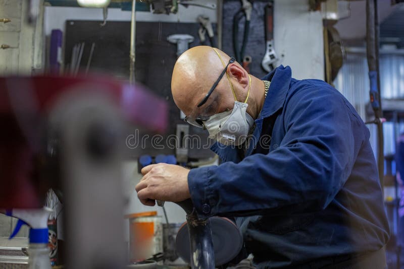 Heavy Industry Worker Cutting Steel with Angle Grinder at Car Service ...