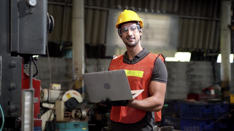 Heavy Industry Worker Man with Laptop Computer is Checking and ...