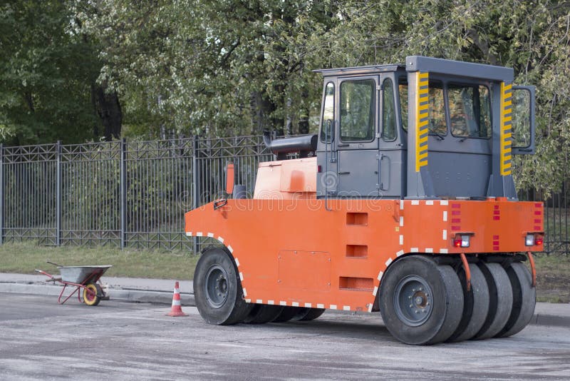 Heavy Machinery Against Hand Tools Stock Photo - Image of street ...