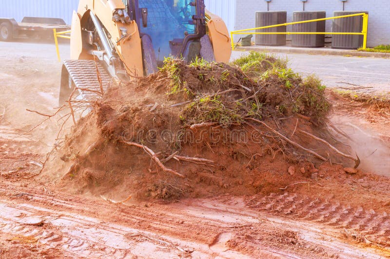 Heavy Machinery Clears Debris and Soil from Construction Site in Bright ...