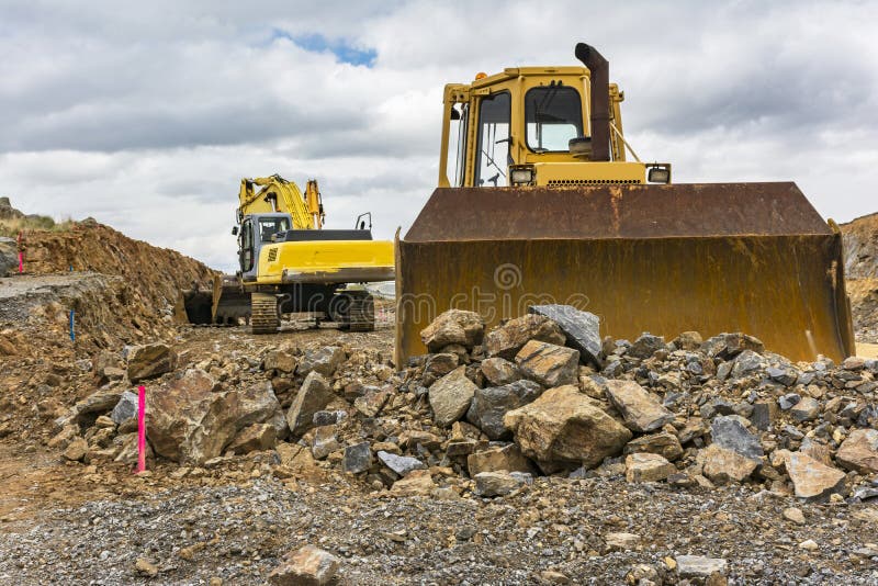 Construction Site with an Excavator Moving Rock Stock Image - Image of ...