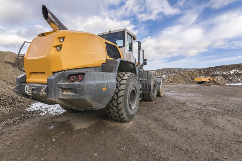 Heavy Machinery at a Construction Site, Excavators Moving Rock and ...